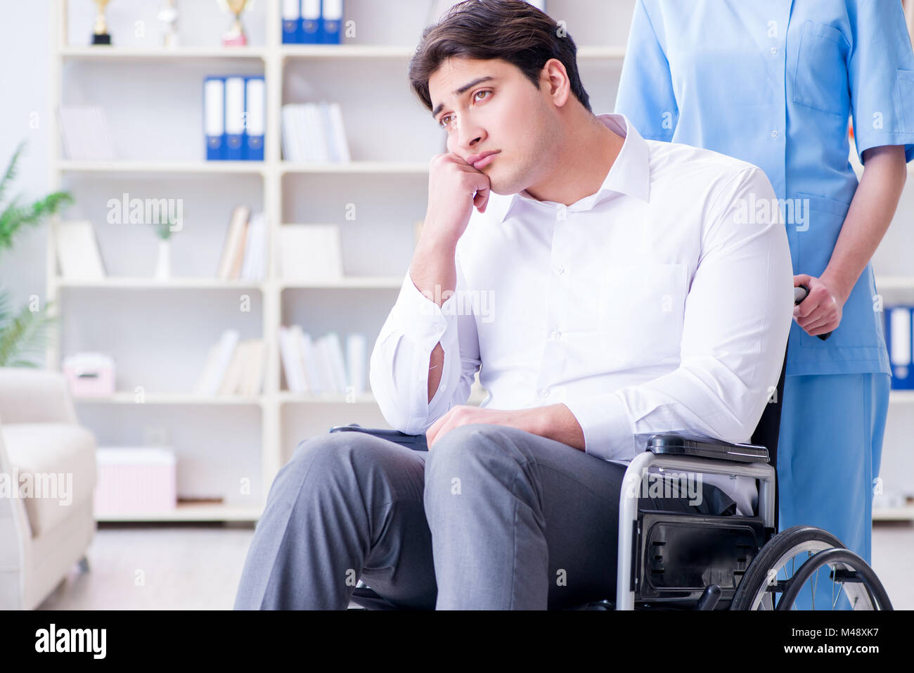 Disabled patient on wheelchair visiting doctor for regular check up ...