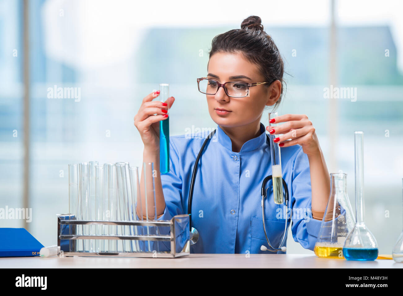 Woman doctor doing chemical tests in laboratory Stock Photo - Alamy