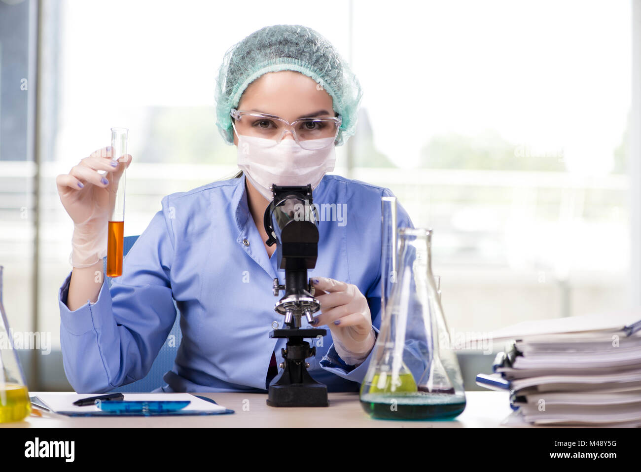 Experienced lab assistant working on chemical solutions Stock Photo - Alamy