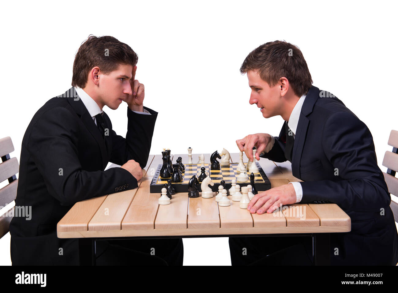 Twin brothers playing chess isolated on white Stock Photo - Alamy