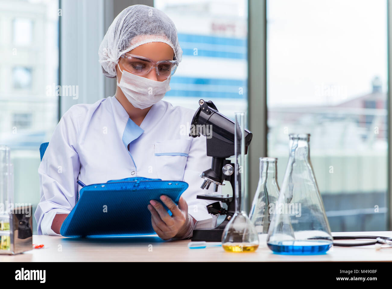 Young student working with chemical solutions in lab Stock Photo - Alamy