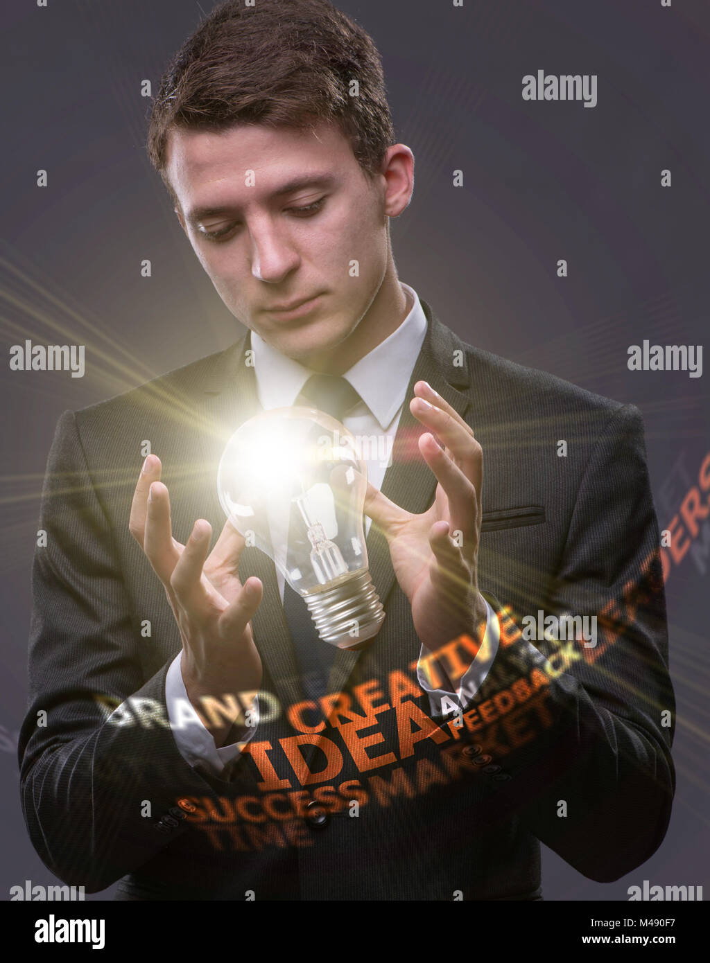Young businessman with light bulb in idea concept Stock Photo - Alamy