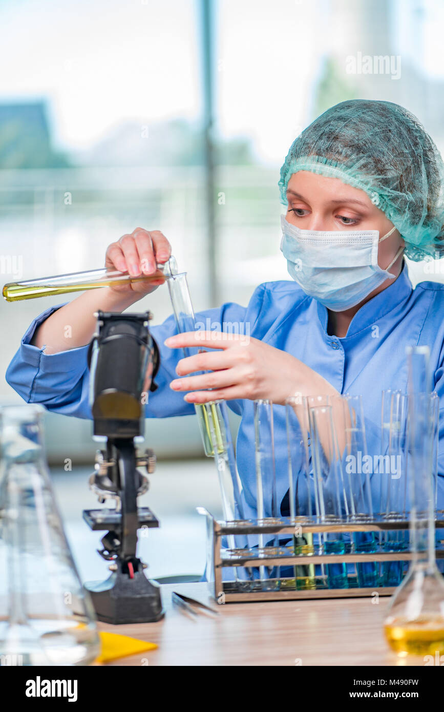 Experienced lab assistant working on chemical solutions Stock Photo - Alamy