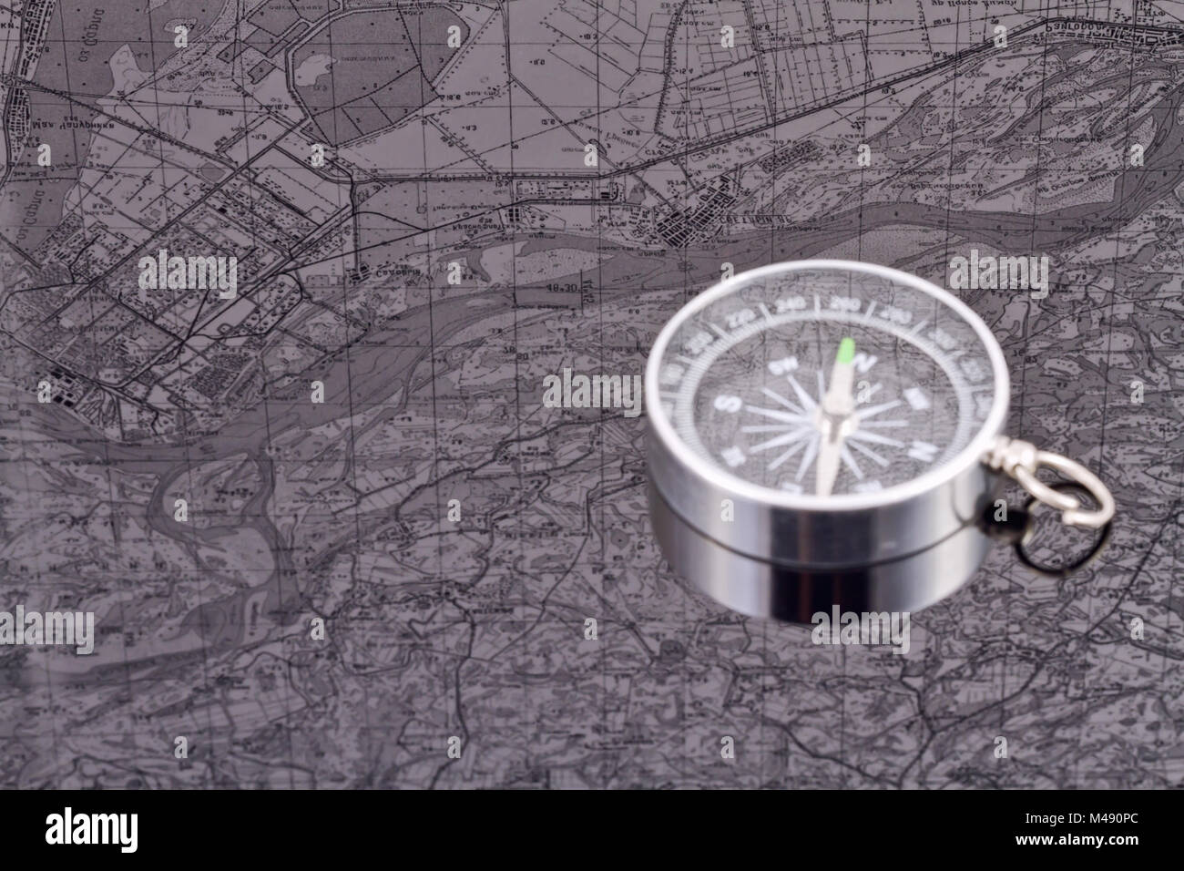 compass on the background of the reflection maps Stock Photo - Alamy