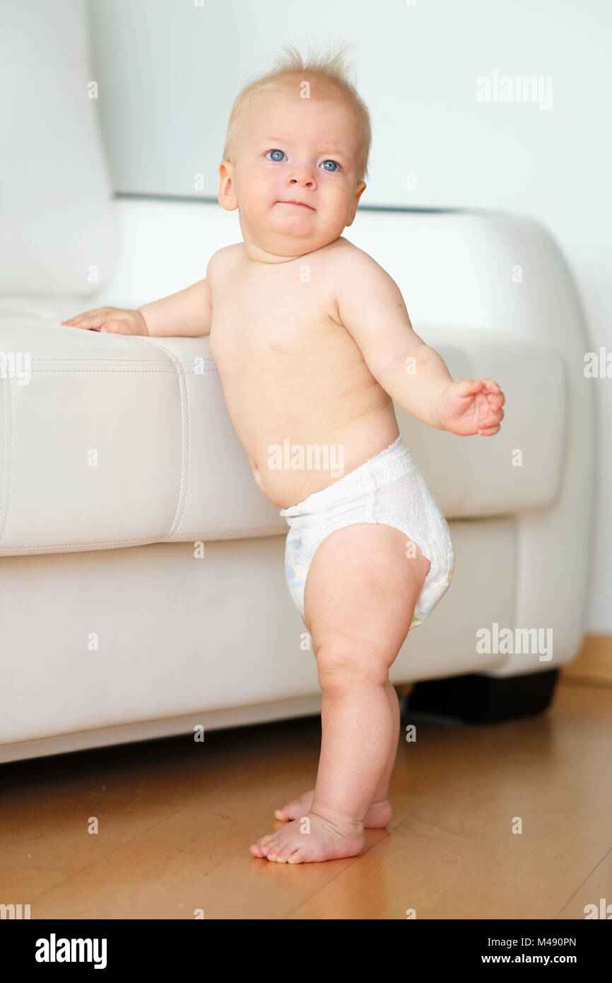 Baby boy standing Stock Photo - Alamy
