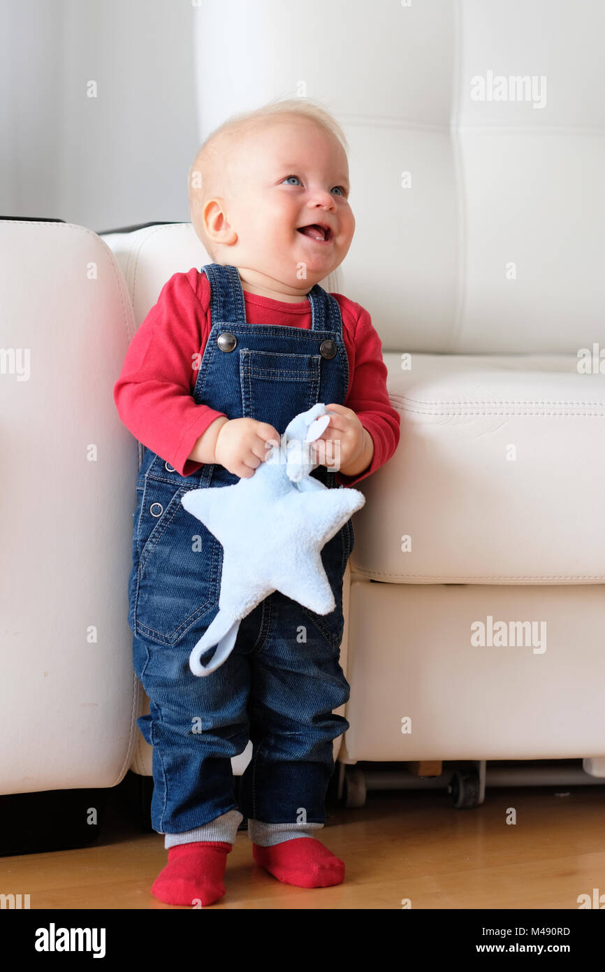 Baby boy standing Stock Photo - Alamy