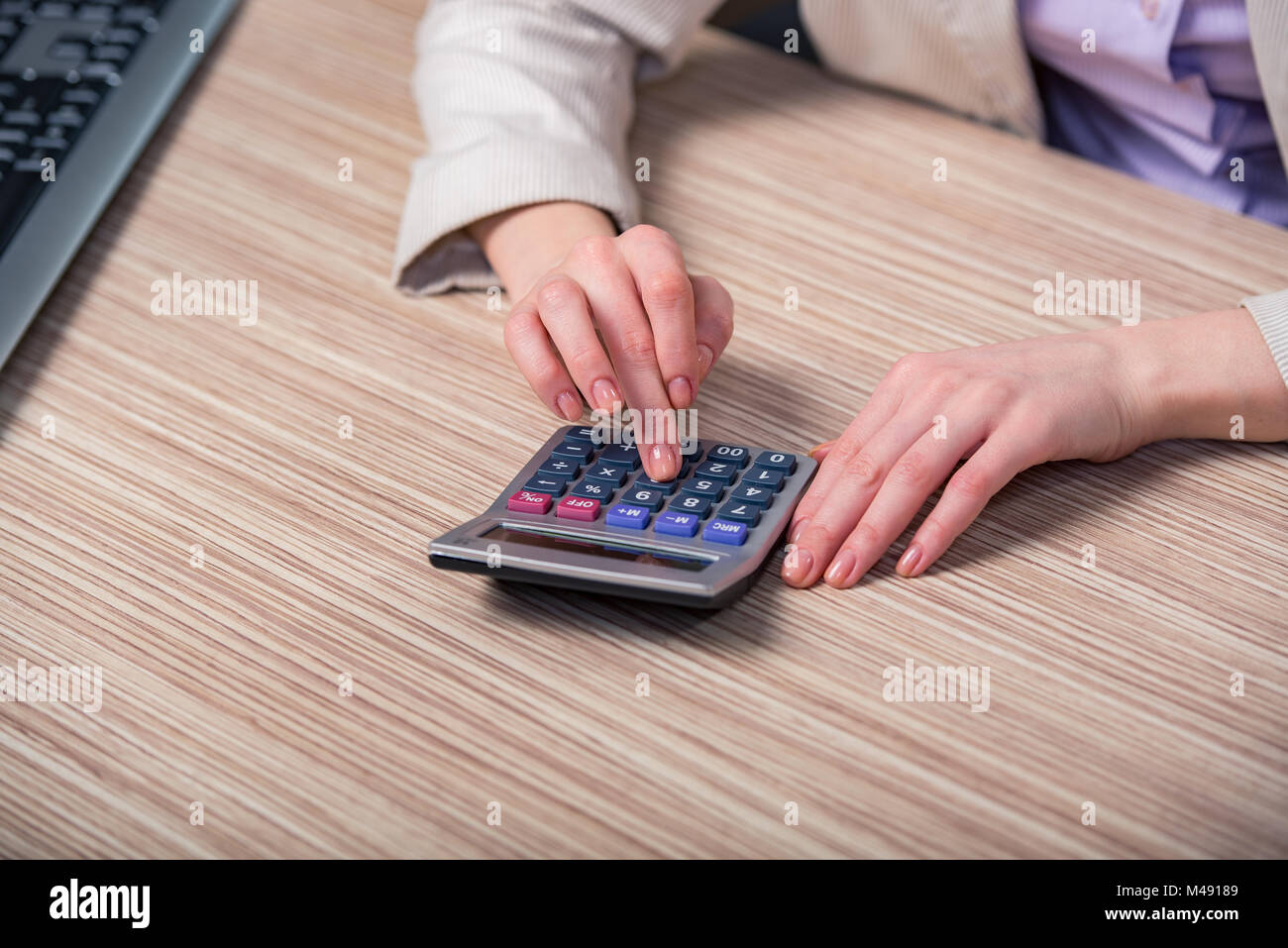 Hands working on the calculator Stock Photo - Alamy
