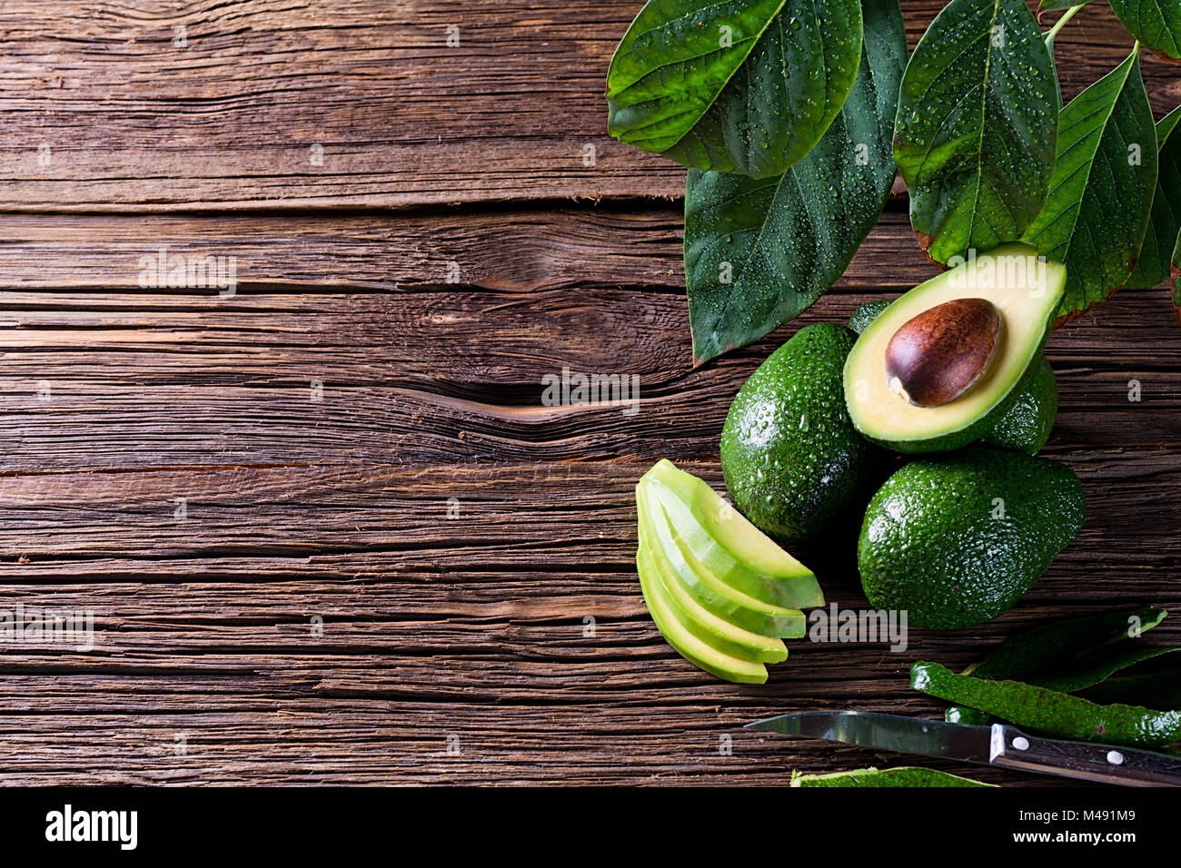 Avocado split in half on old wooden table with free space for your text ...