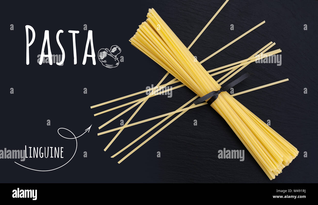 Uncooked Italian pasta Linguine on black slate stone background Stock ...