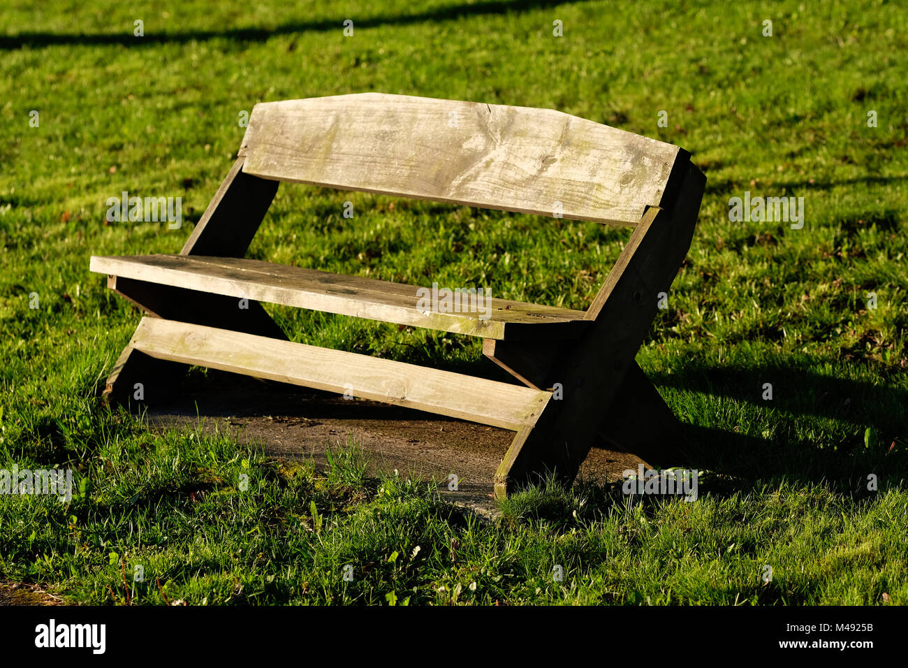 Wooden bench on the meadow Stock Photo - Alamy