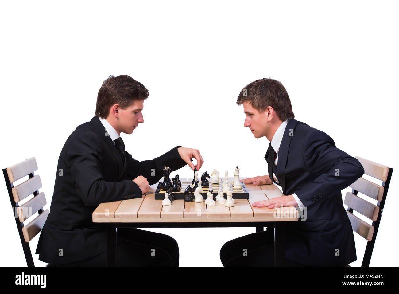 Twin brothers playing chess isolated on white Stock Photo - Alamy