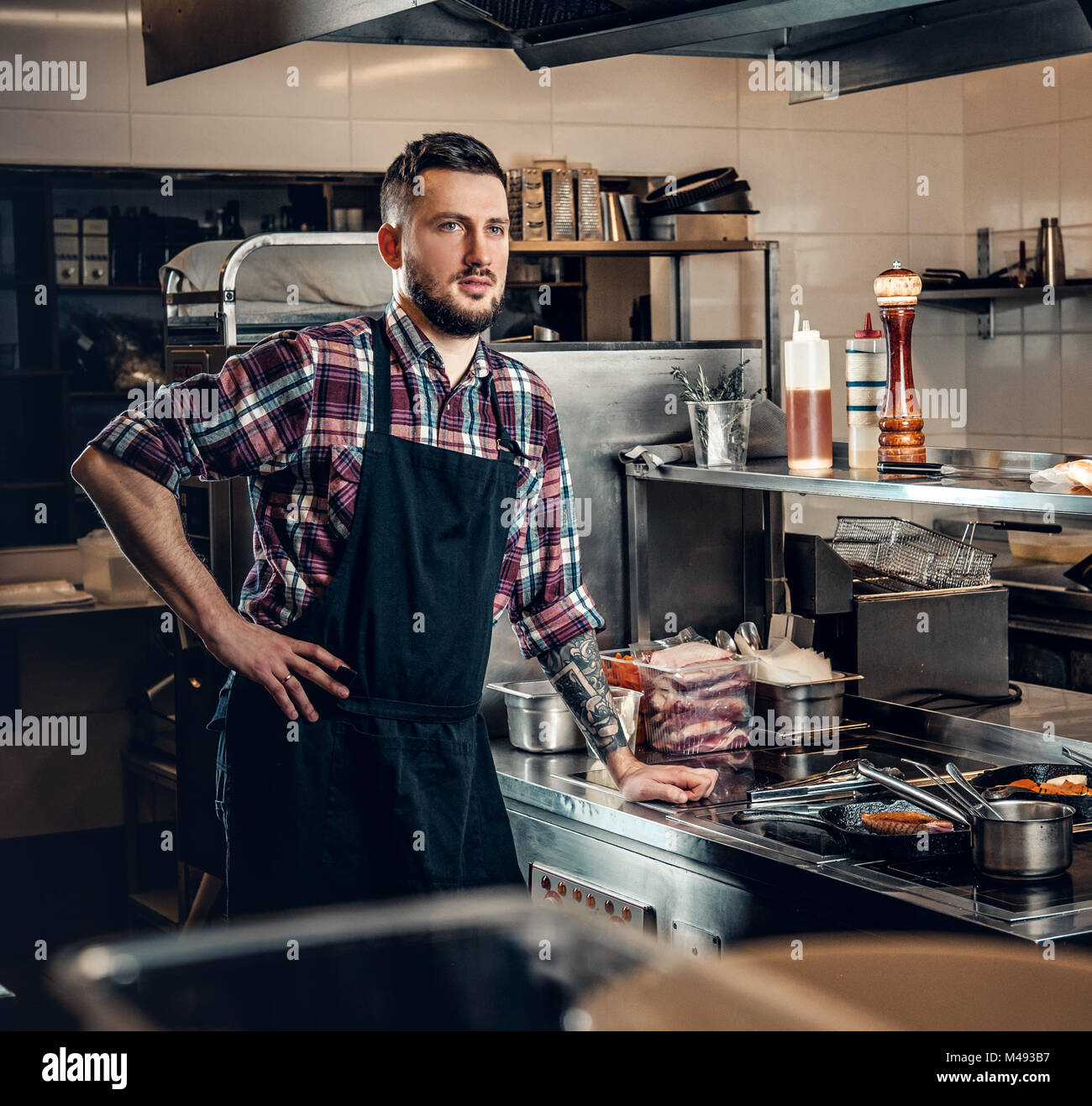 Portrait of stylish cook on a kitchen Stock Photo - Alamy
