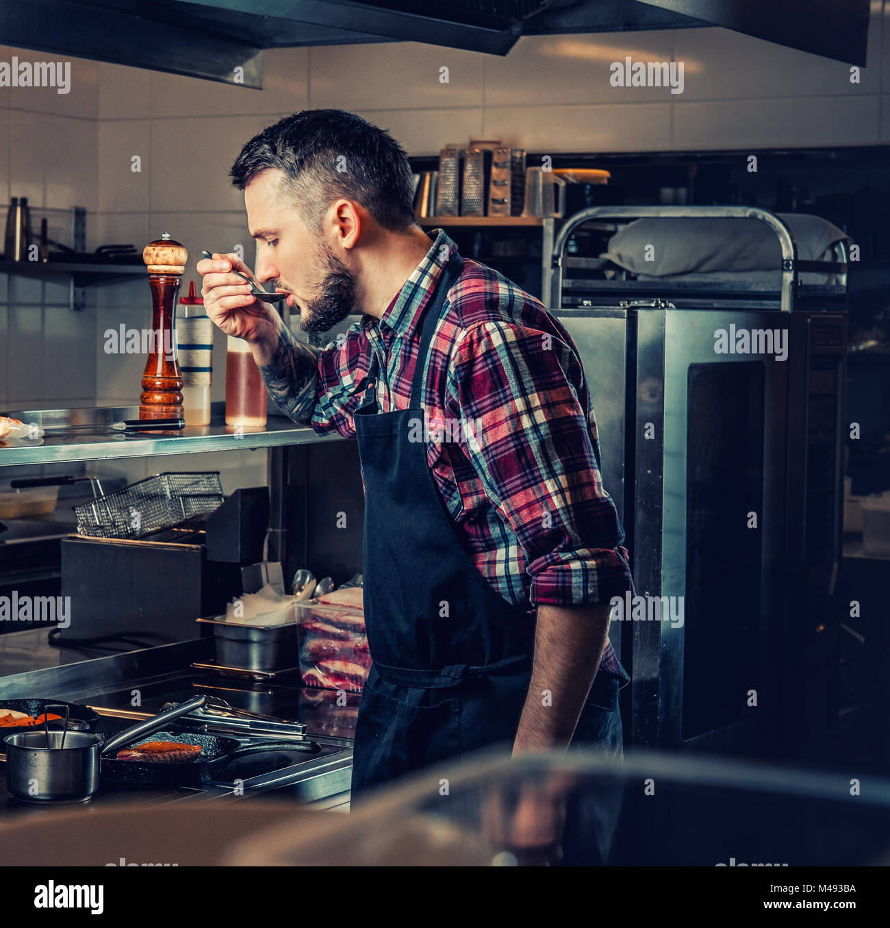 Chef tasting a soup in a kitchen Stock Photo - Alamy