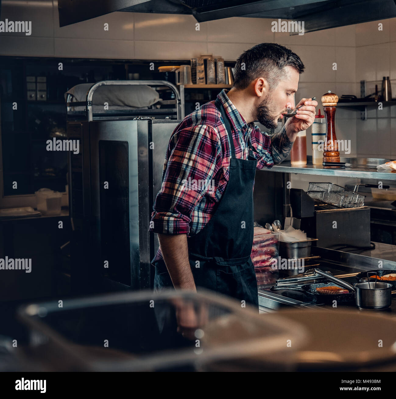 Chef tasting a soup in a kitchen Stock Photo - Alamy