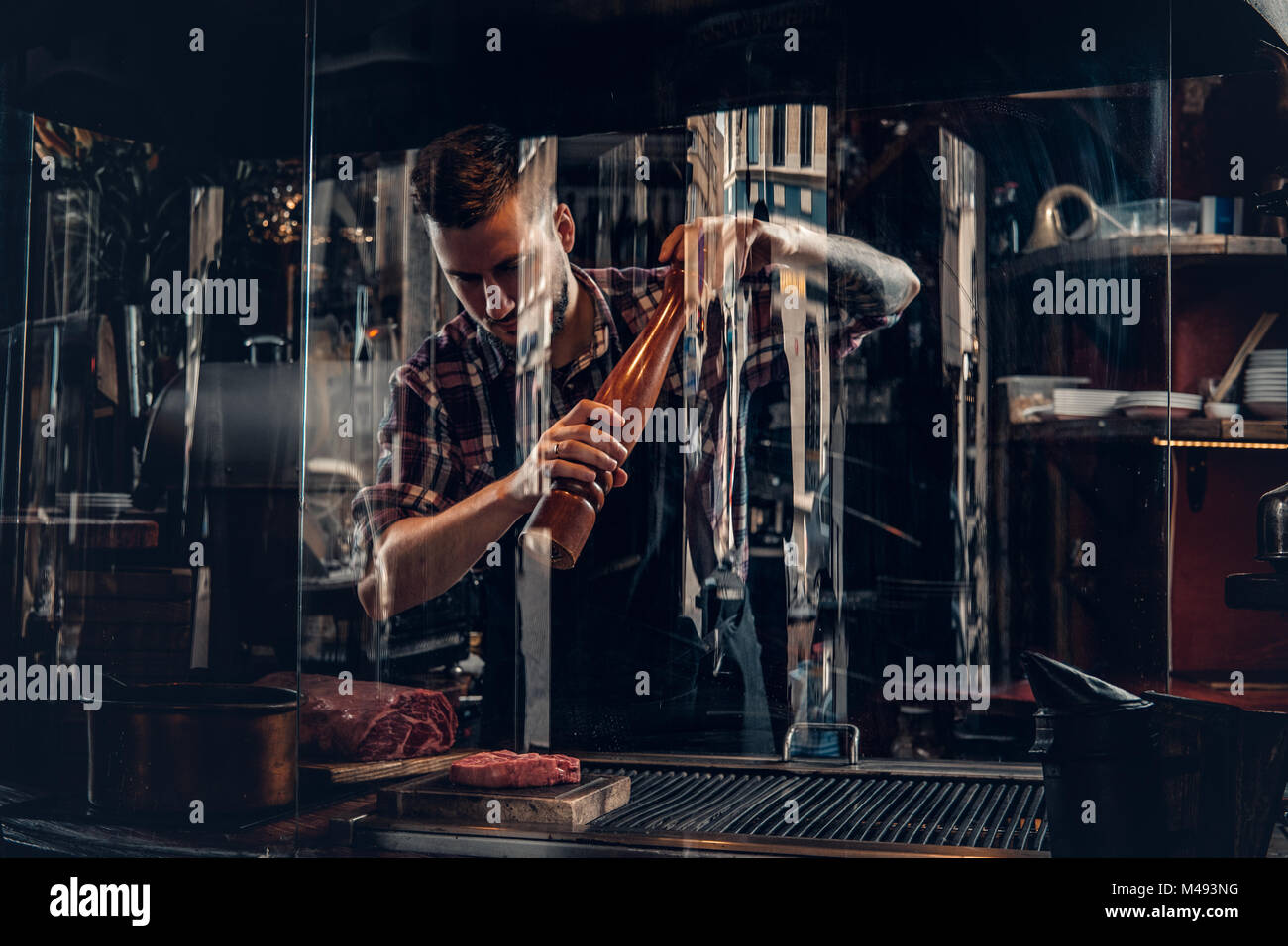 Bearded chef cooking beef steak Stock Photo - Alamy