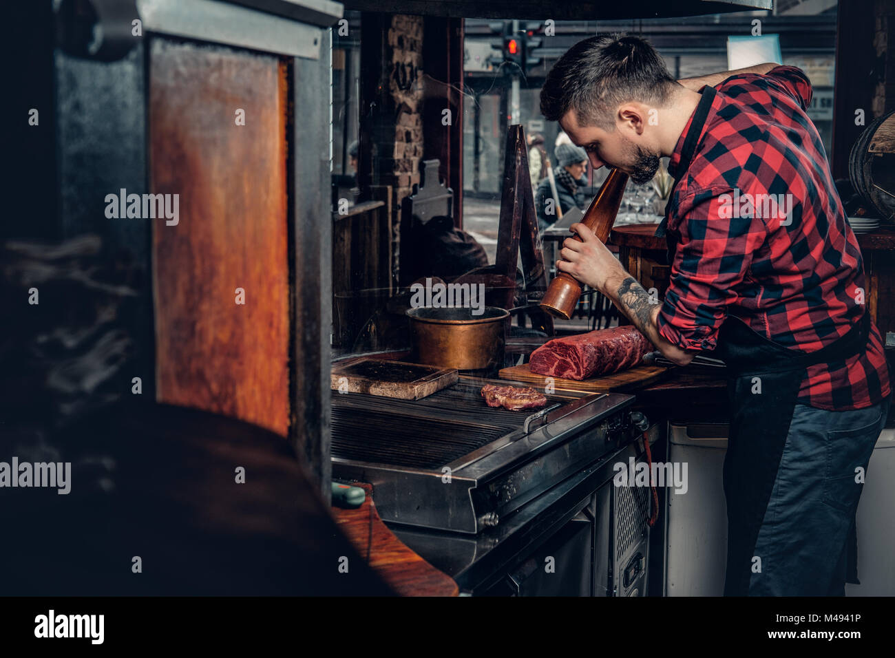 Bearded chef cooking beef steak Stock Photo - Alamy