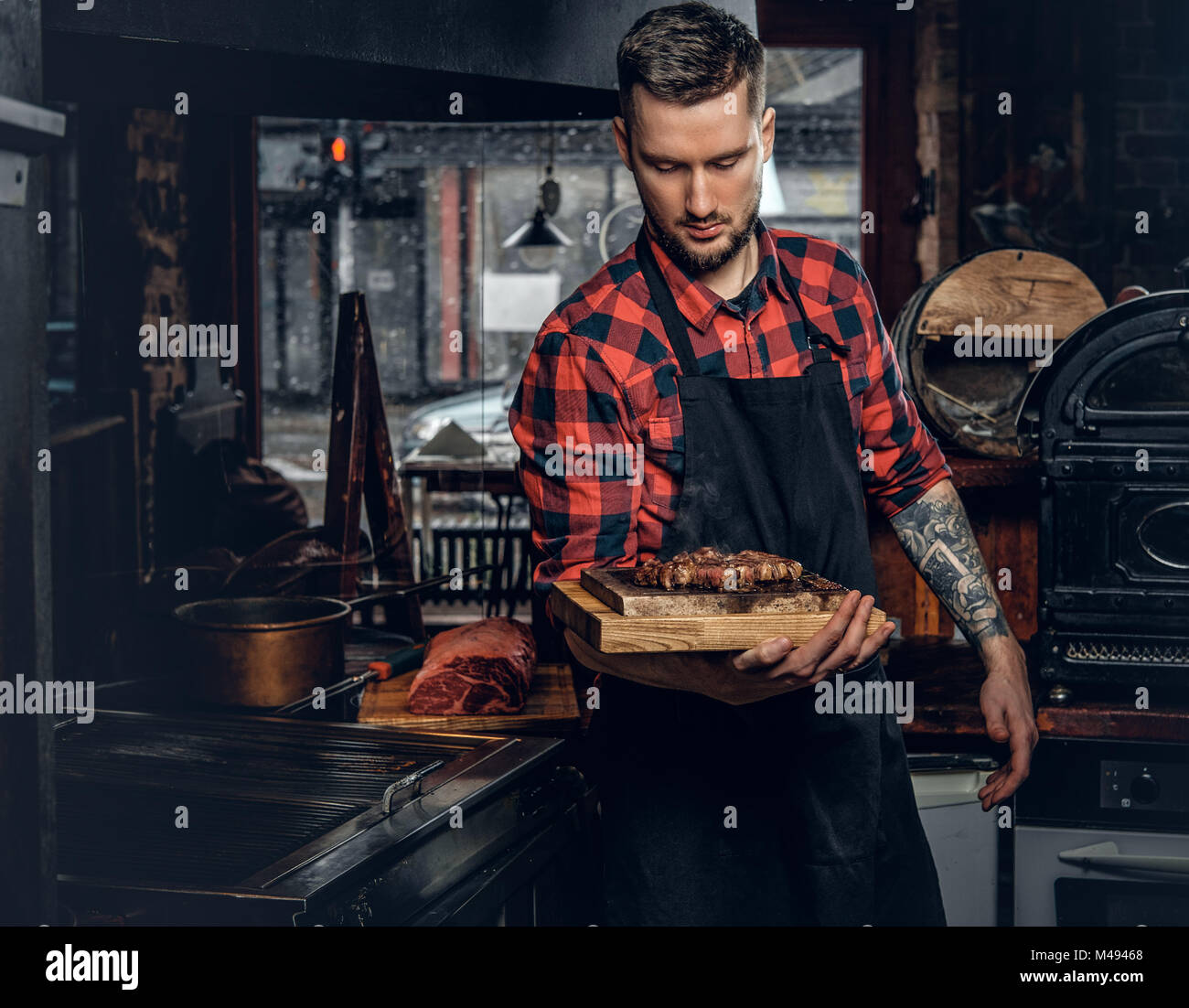 Cheef cook prepairing a meat on a kitchen Stock Photo - Alamy