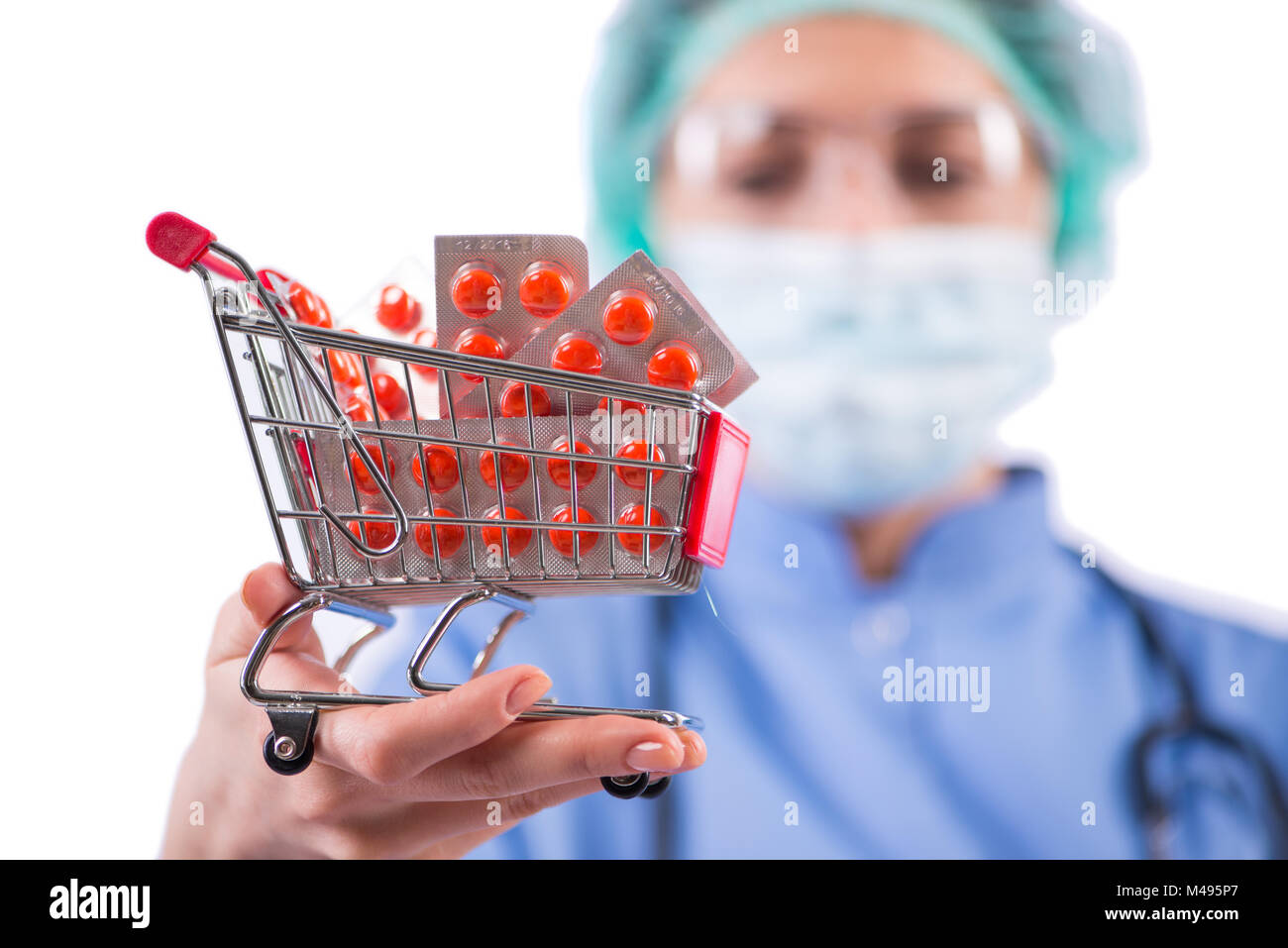 Doctor with shopping cart full of pills isolated on white Stock Photo ...