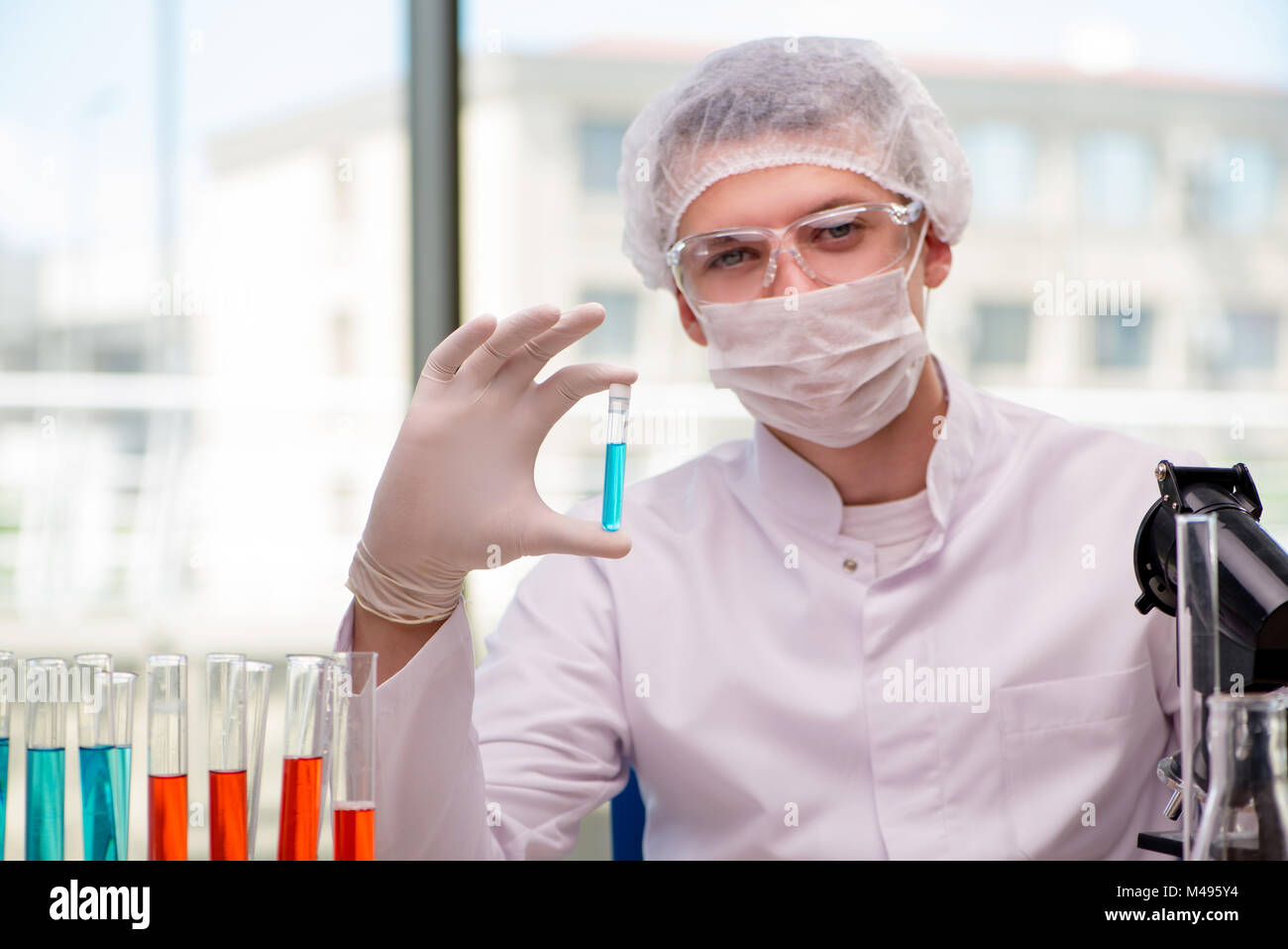 Man working in the chemical lab on science project Stock Photo - Alamy