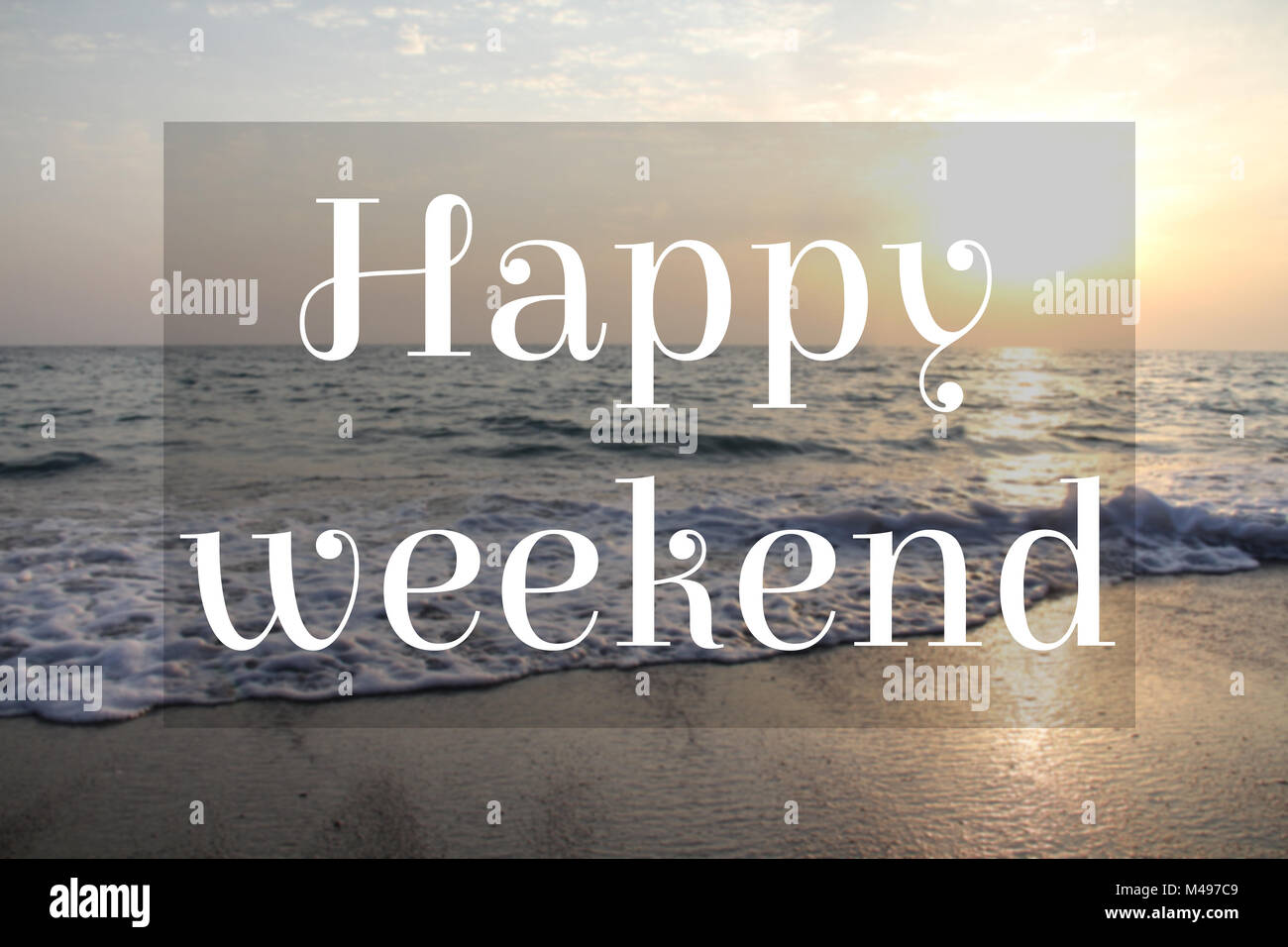 Sunset sky at the sea with text: Happy weekend Stock Photo - Alamy