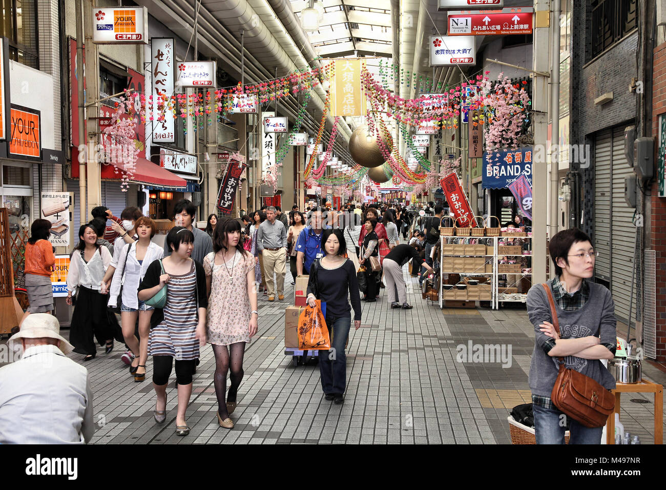 NAGOYA, JAPAN - APRIL 28: Shoppers walk along Osu Kannon covered ...