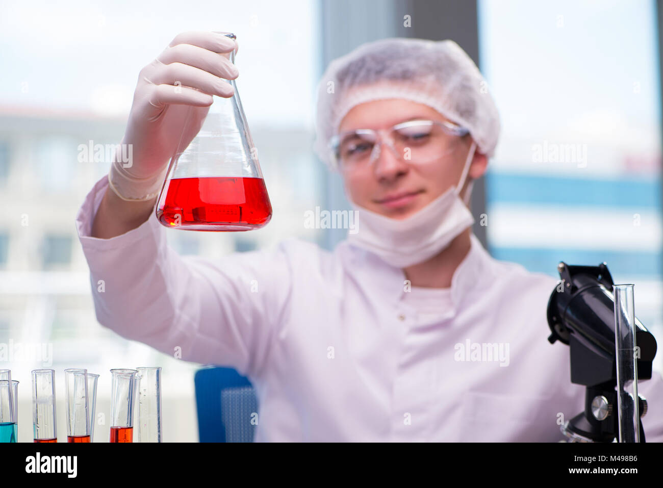 Man working in the chemical lab on science project Stock Photo - Alamy