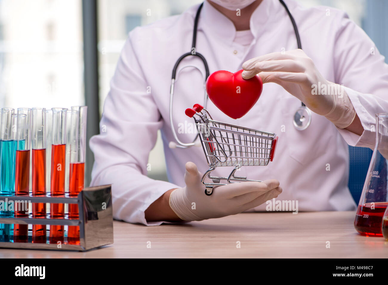 Doctor curing heart in medical concept Stock Photo - Alamy