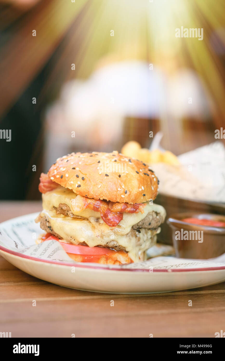 Cheeseburger in outdoor restaurant Stock Photo - Alamy