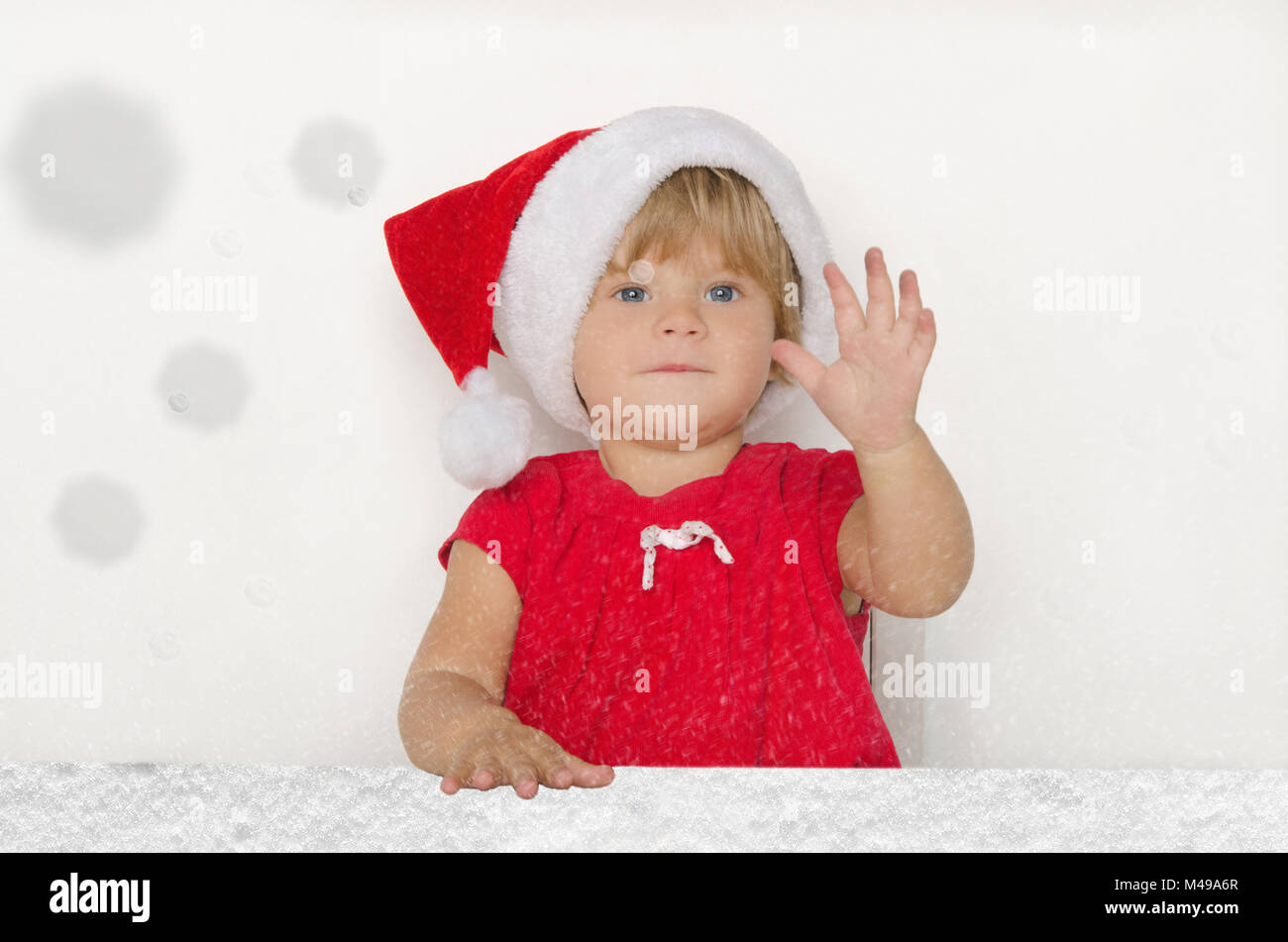 little baby dressed as Santa under the falling snow Stock Photo - Alamy