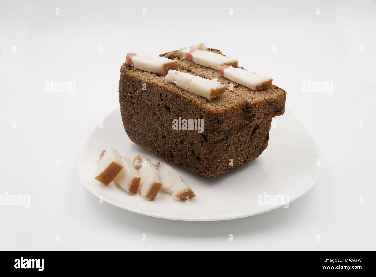Rye bread and slices of fat. On a white background Stock Photo - Alamy