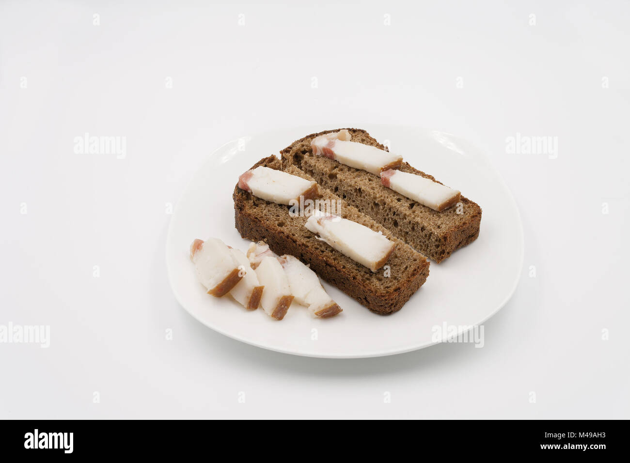 Rye bread and slices of fat. On a white background Stock Photo - Alamy