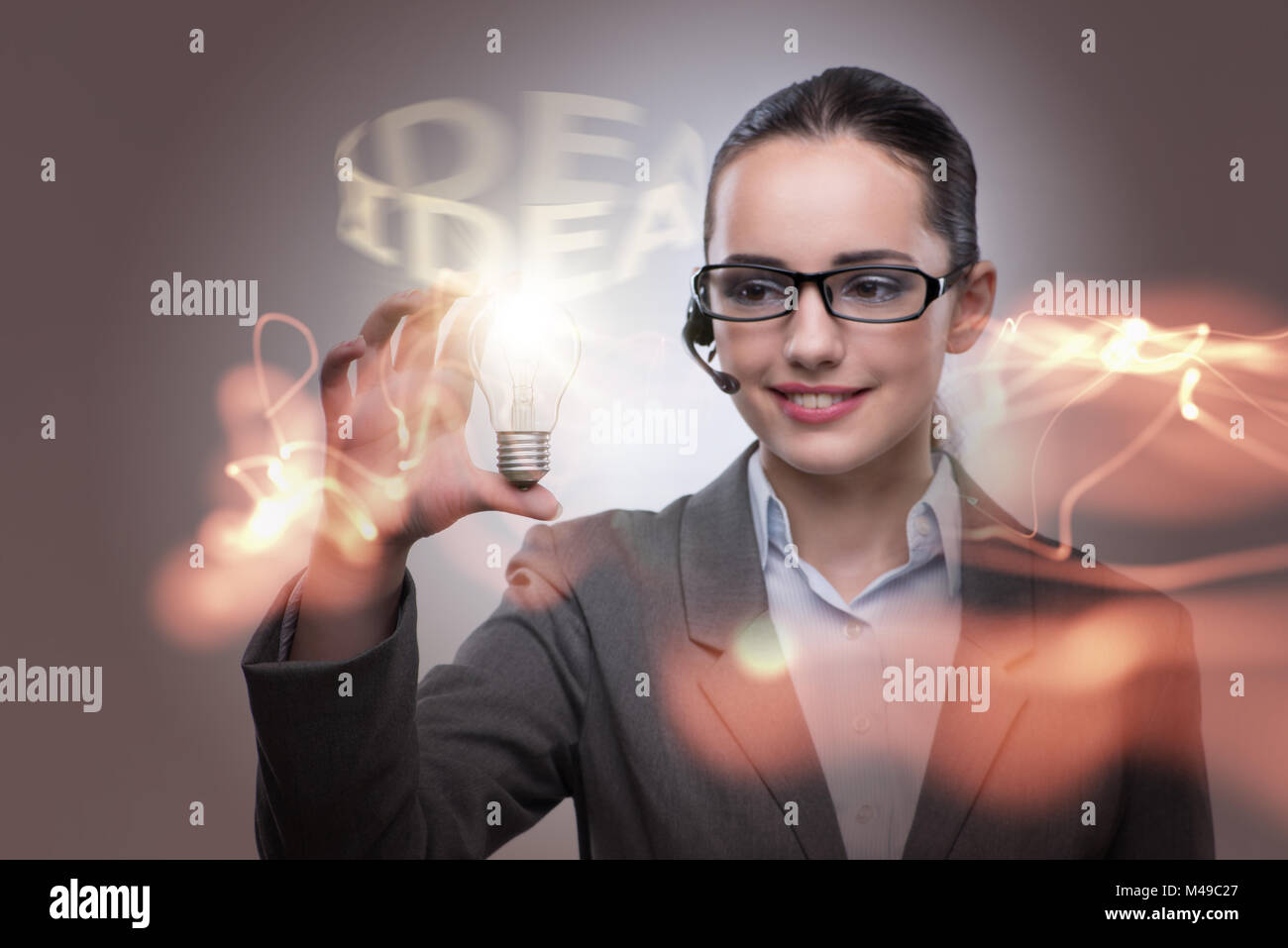 Young call center operator with bulb in idea concept Stock Photo - Alamy