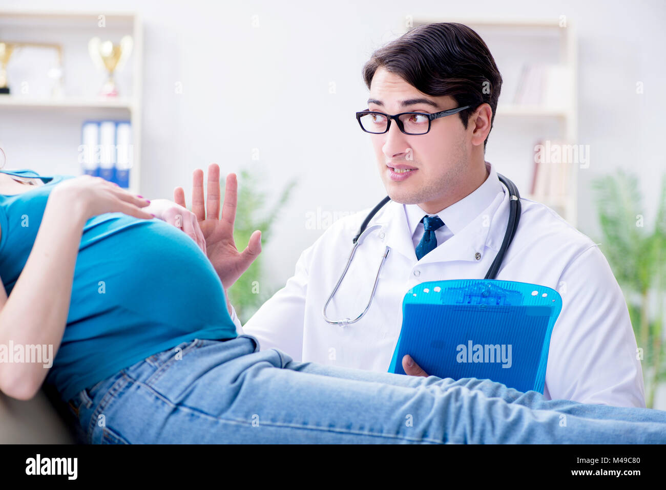 Doctor examining pregnant female patient in hospital Stock Photo - Alamy