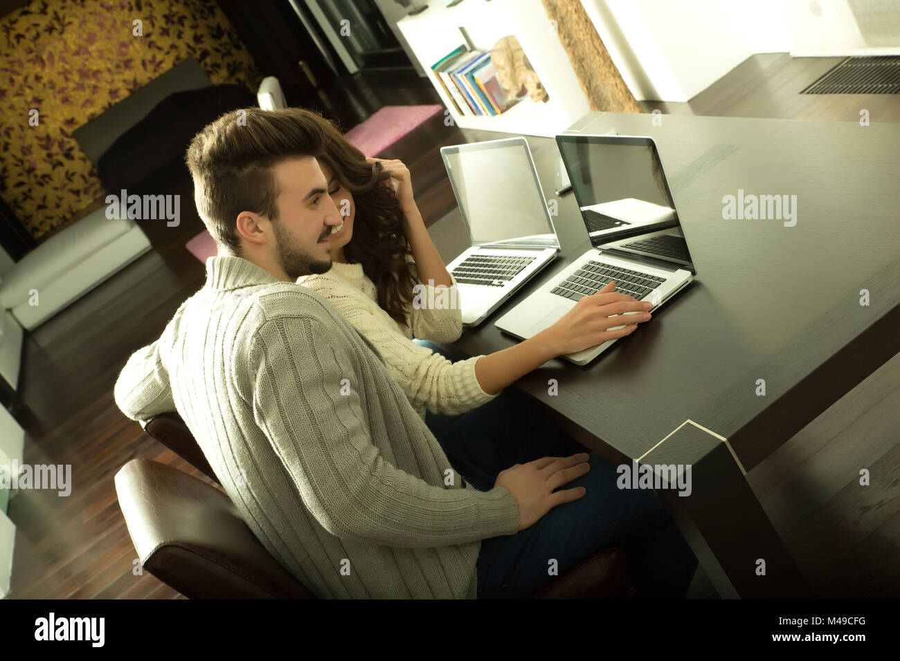 Young couple having fun with their Laptop computers at home Stock Photo ...