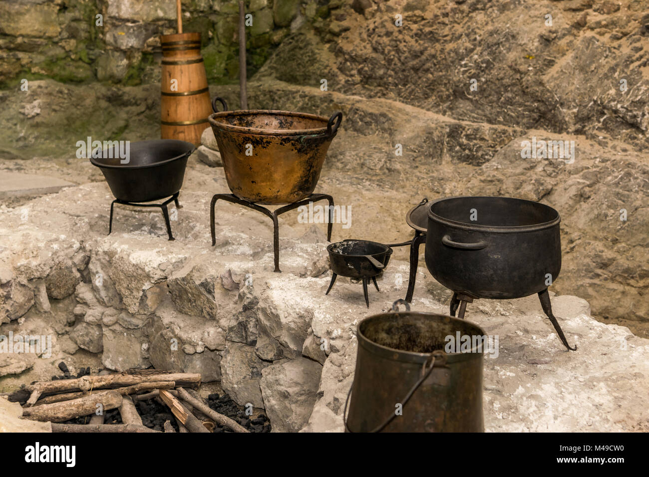 Medieval kitchen with tools, baskets, scale, fireplace Stock Photo - Alamy
