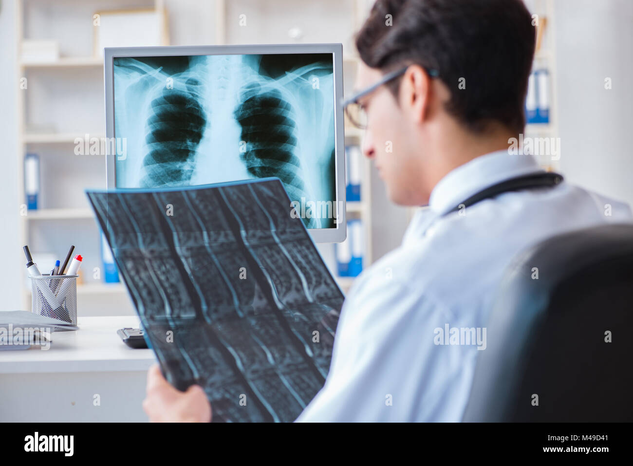 Doctor radiologist looking at x-ray images Stock Photo - Alamy