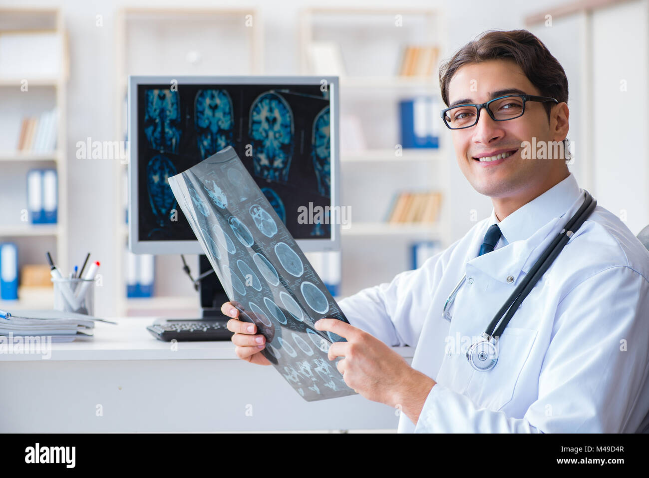 Doctor radiologist looking at x-ray images Stock Photo - Alamy