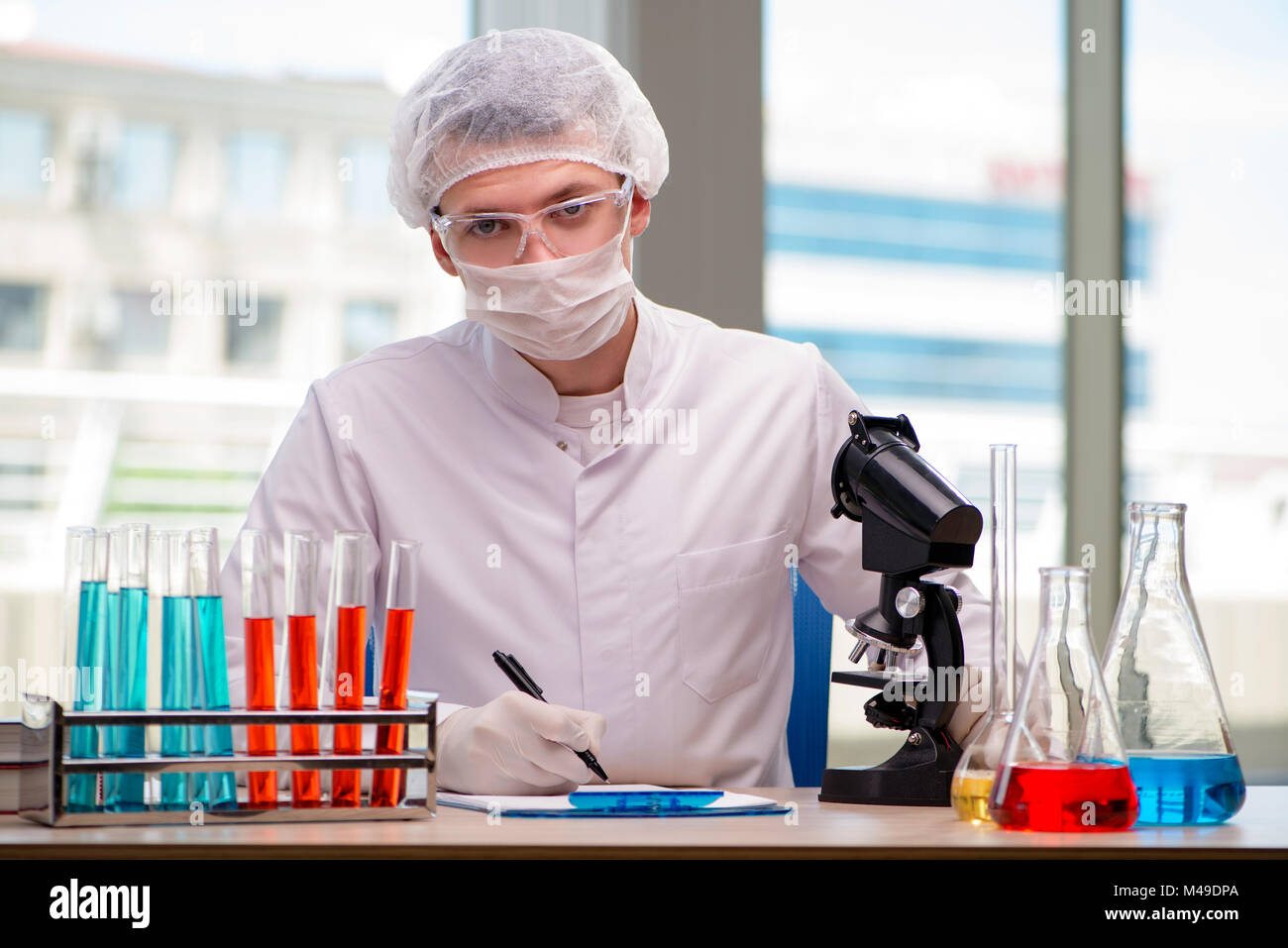 Man working in the chemical lab on science project Stock Photo - Alamy