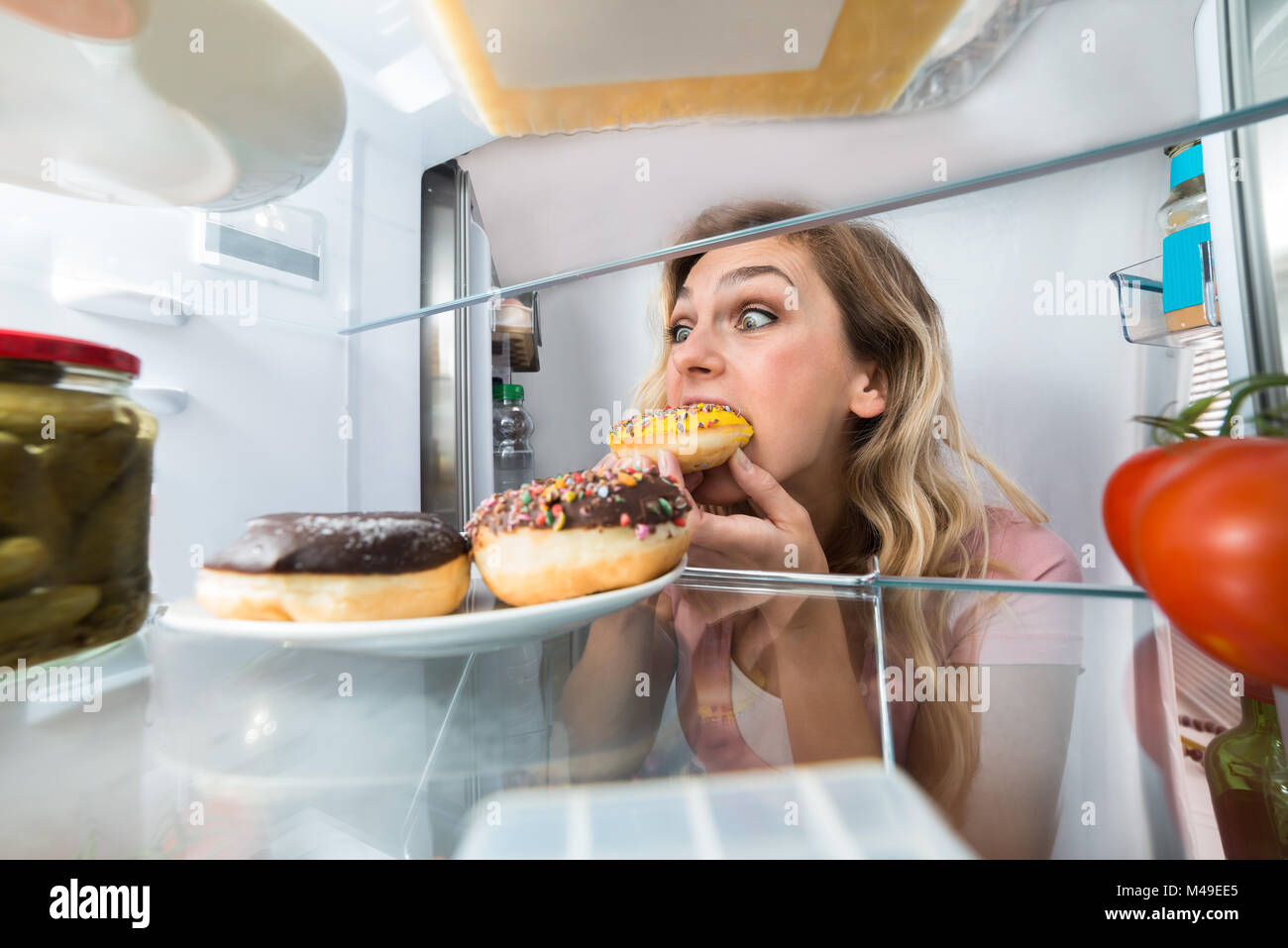 Funny woman eating donut hi-res stock photography and images - Alamy