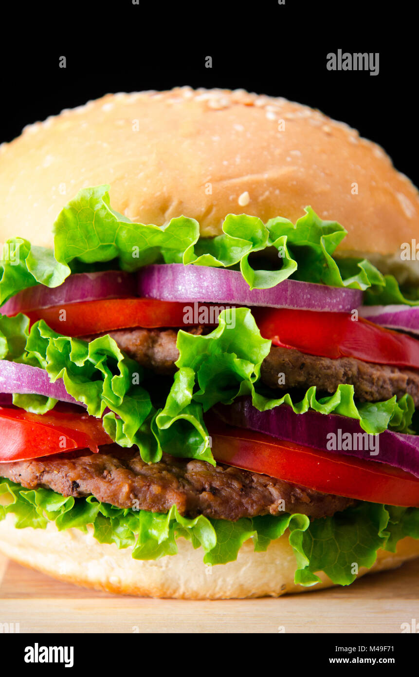 Burger served in bun in nutrition fast food concept Stock Photo - Alamy