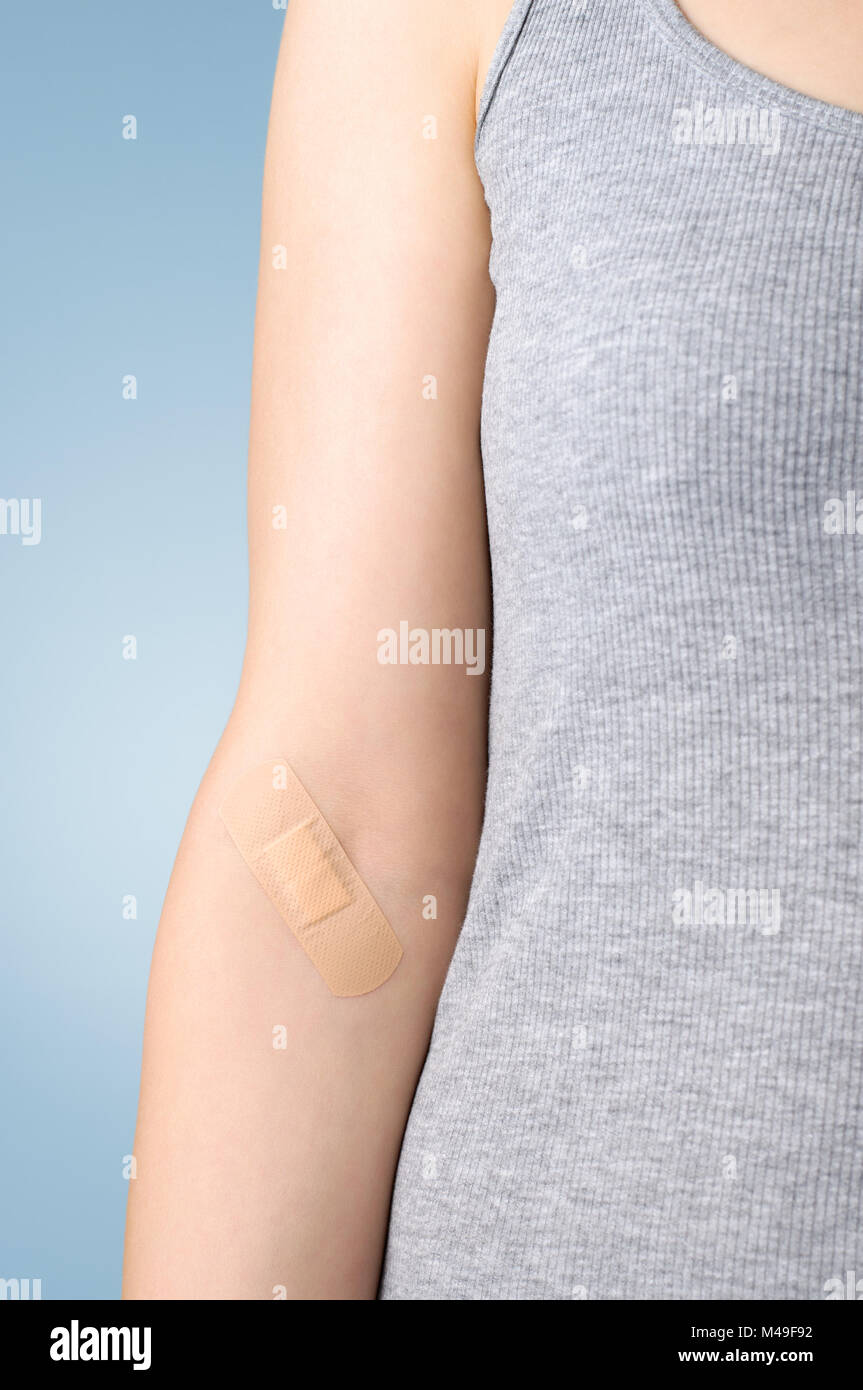 Plaster on female arm Stock Photo - Alamy