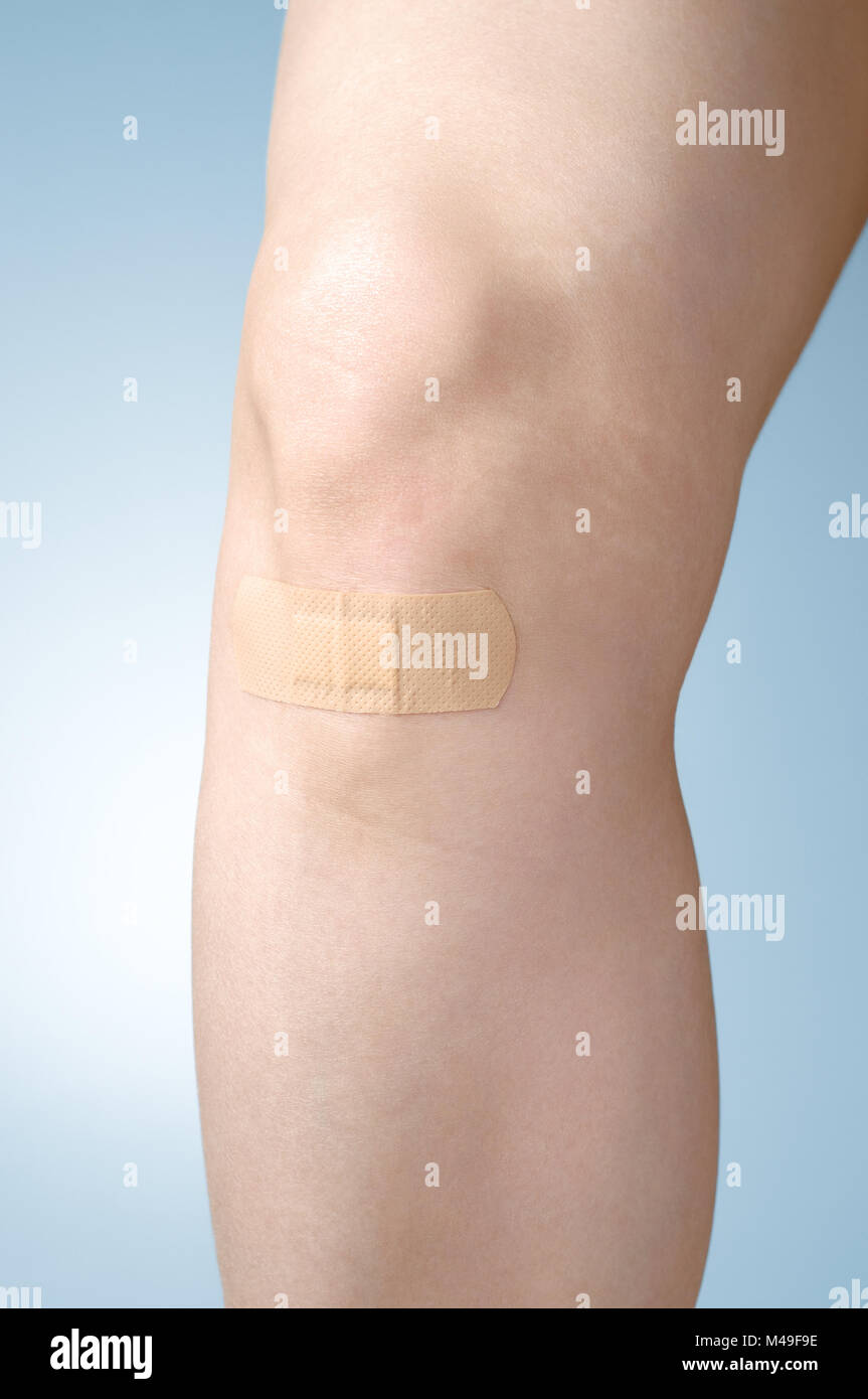 Plaster on female leg Stock Photo - Alamy