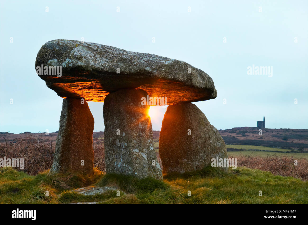 Sunrise casting rays through stones of Lanyon Quoit ancient burial ...