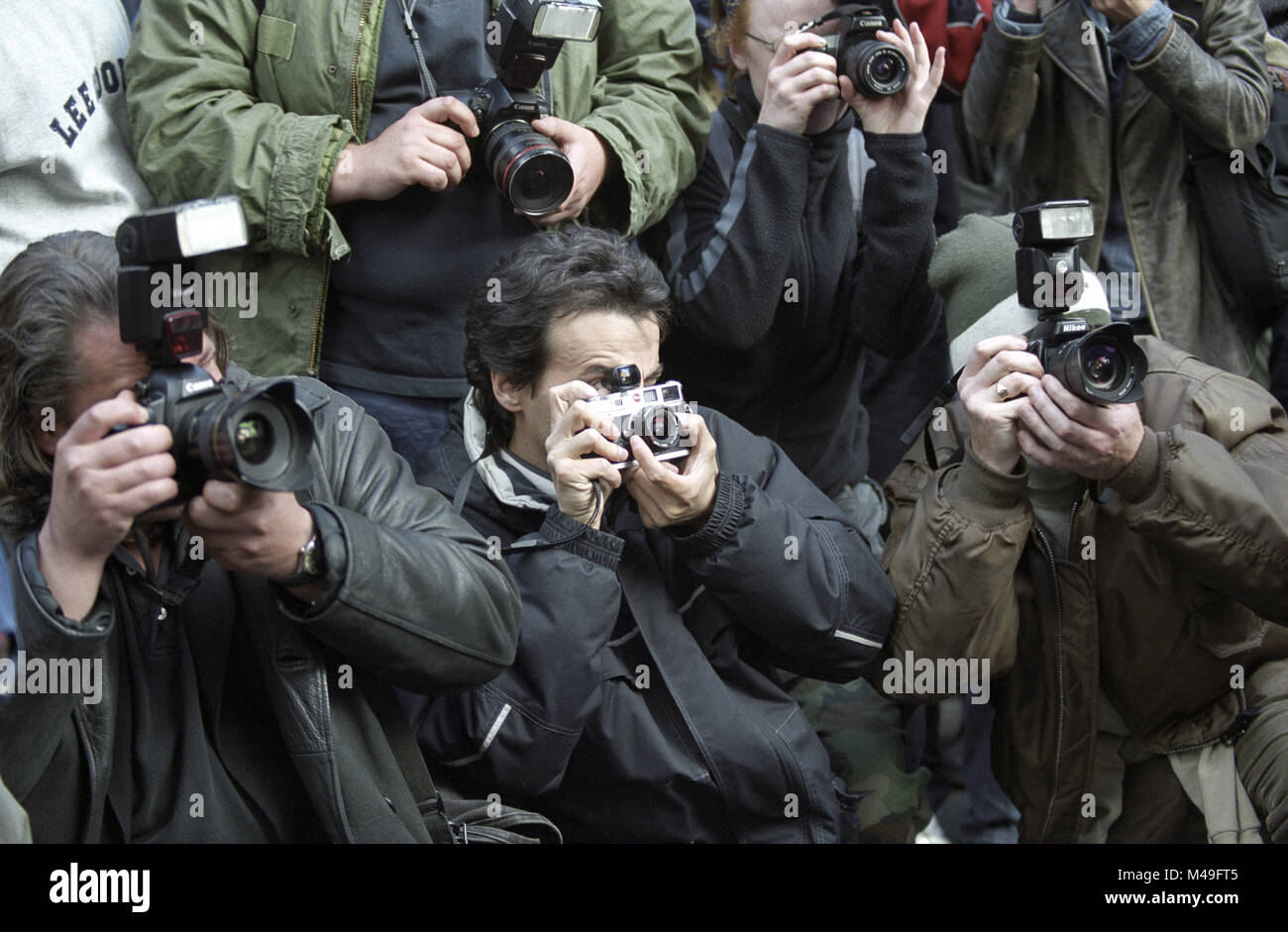Photographers take pictures during May Day protests in London 2002 ...