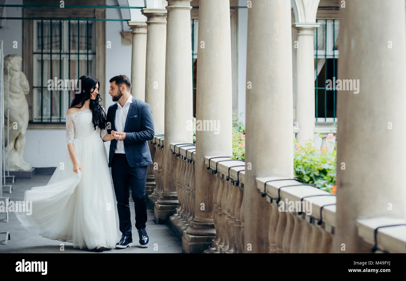 Walk along the old balcony of the stylish newlyweds holding hands and ...