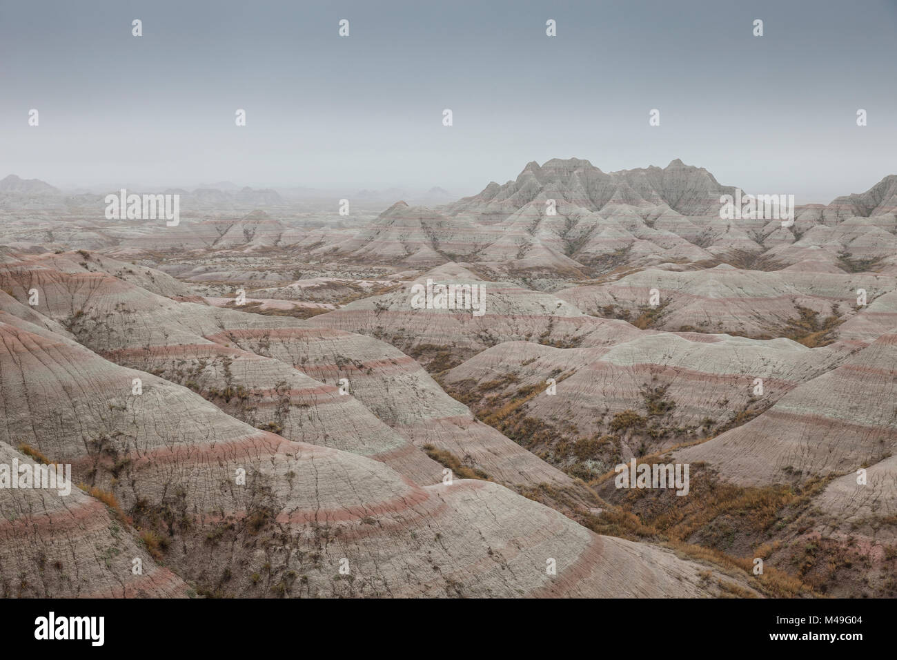 Eroded landscape, Sandstone striations and erosional features, in mist ...