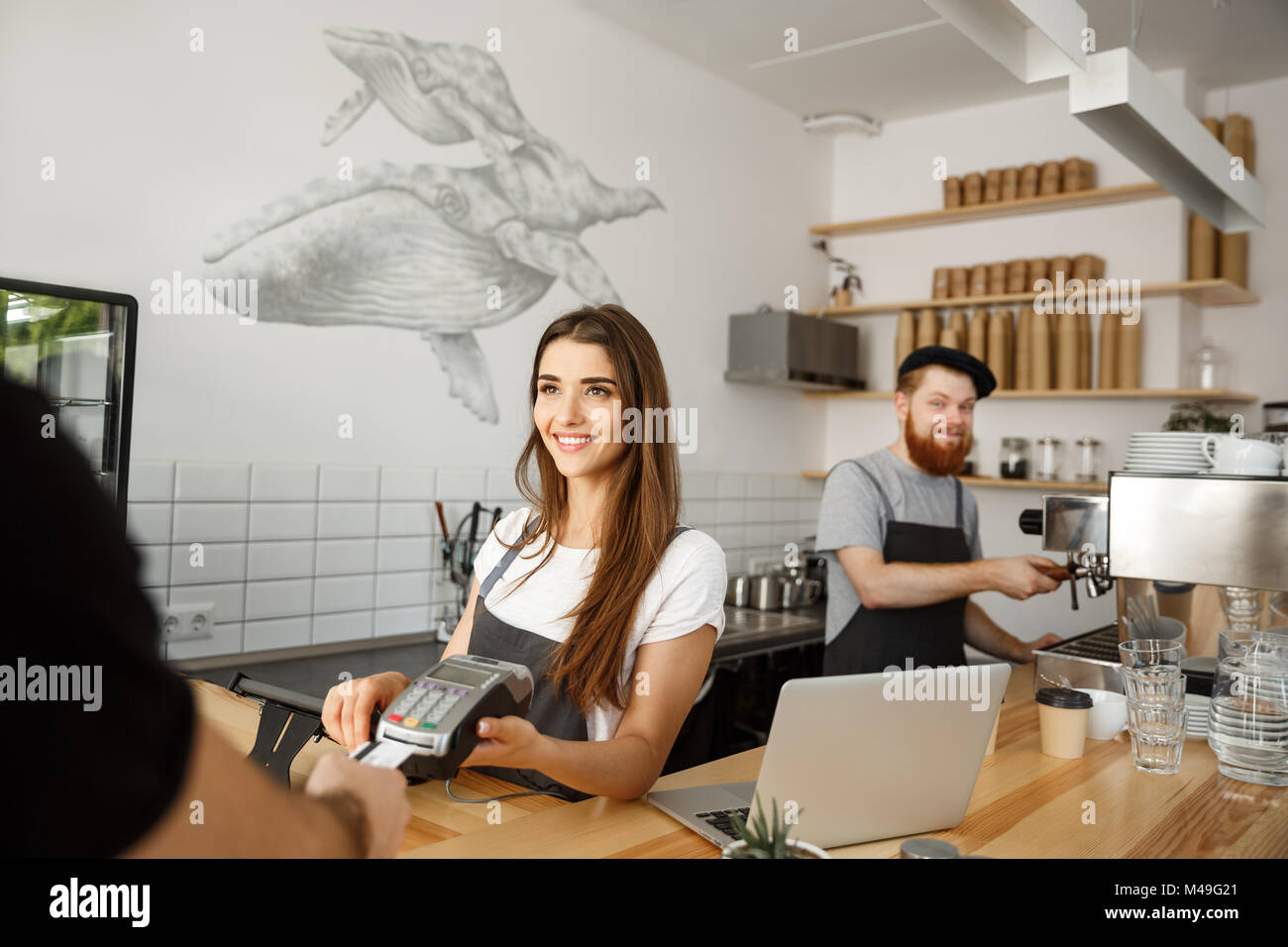 Coffee Business Concept - Beautiful female barista giving payment ...