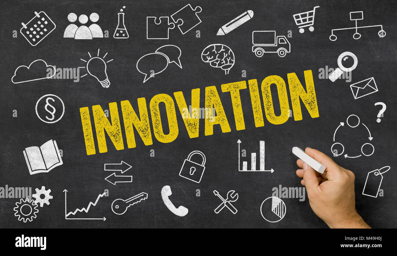 Innovation written on a blackboard with icons Stock Photo - Alamy