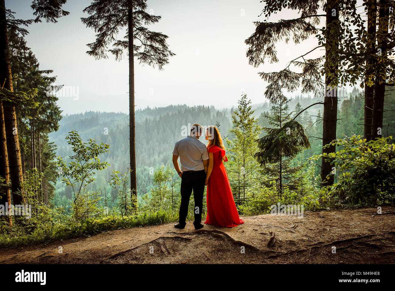 Romantic outdoor full-length portrait. Attractive couple is tenderly ...