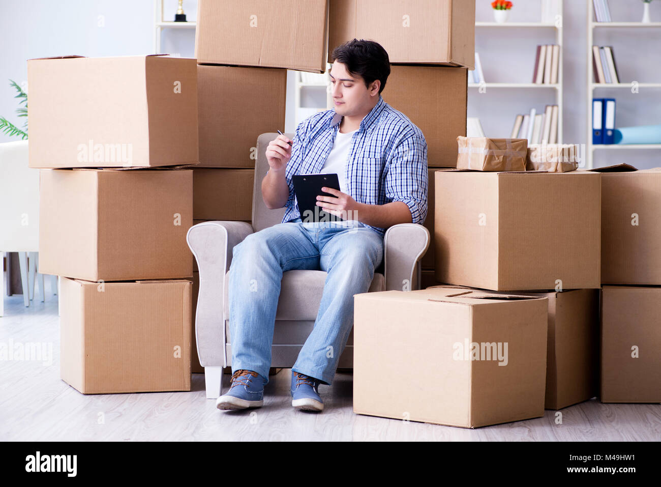 Young man moving in to new house with boxes Stock Photo - Alamy